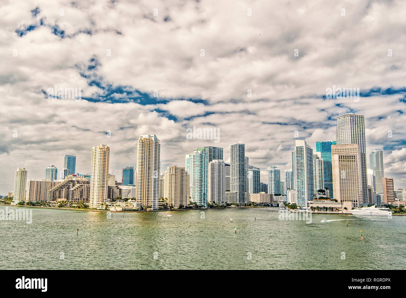 Aerial view of Miami skyscrapers with blue cloudy sky,white boat ...