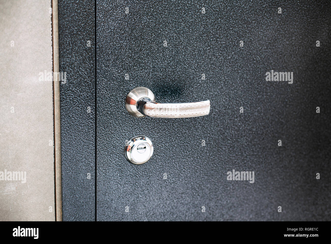 Metal door with handle and keyhole. Close-up Stock Photo - Alamy