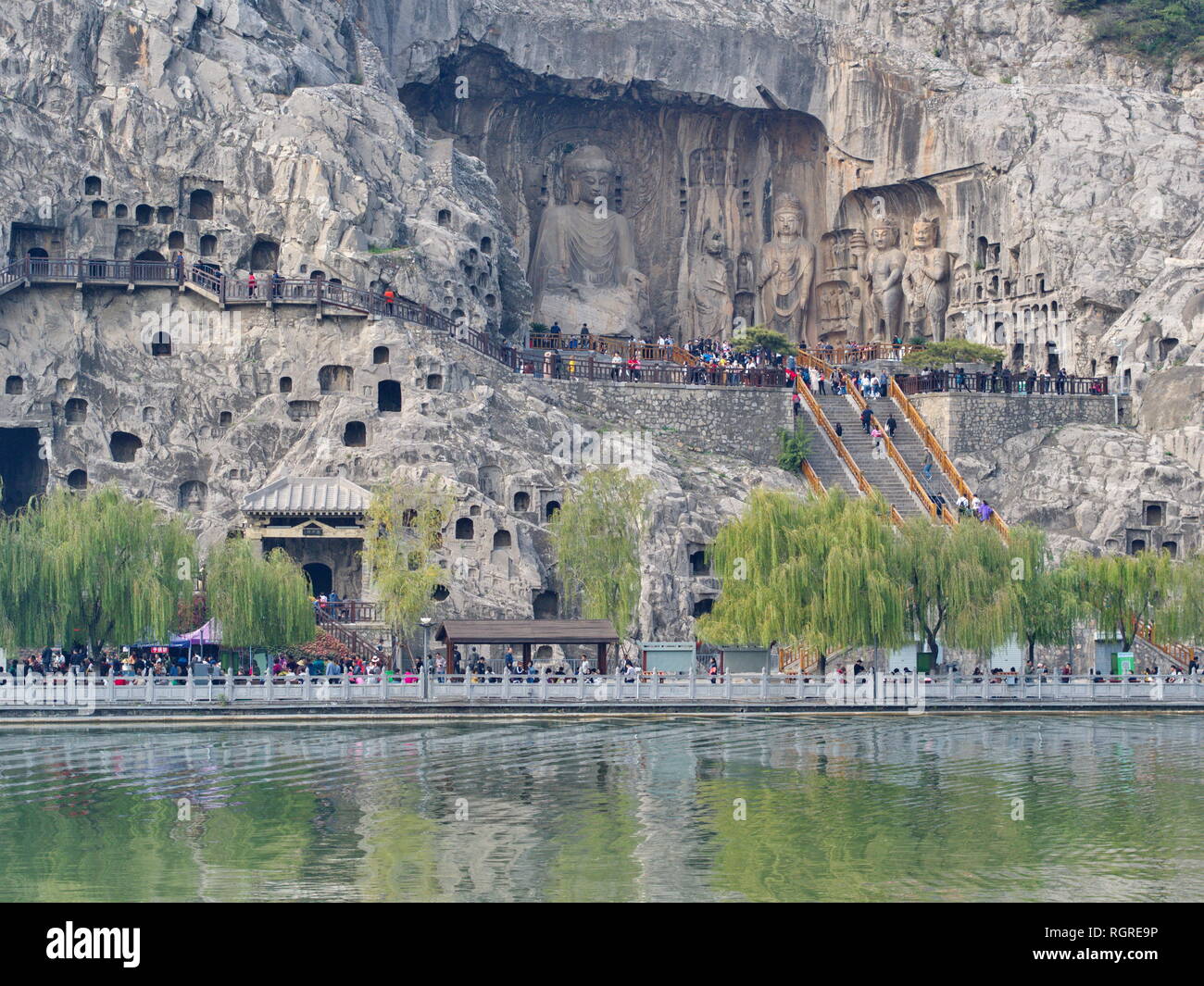 Luoyang Longmen grottoes. Broken Buddha and the stone caves and ...