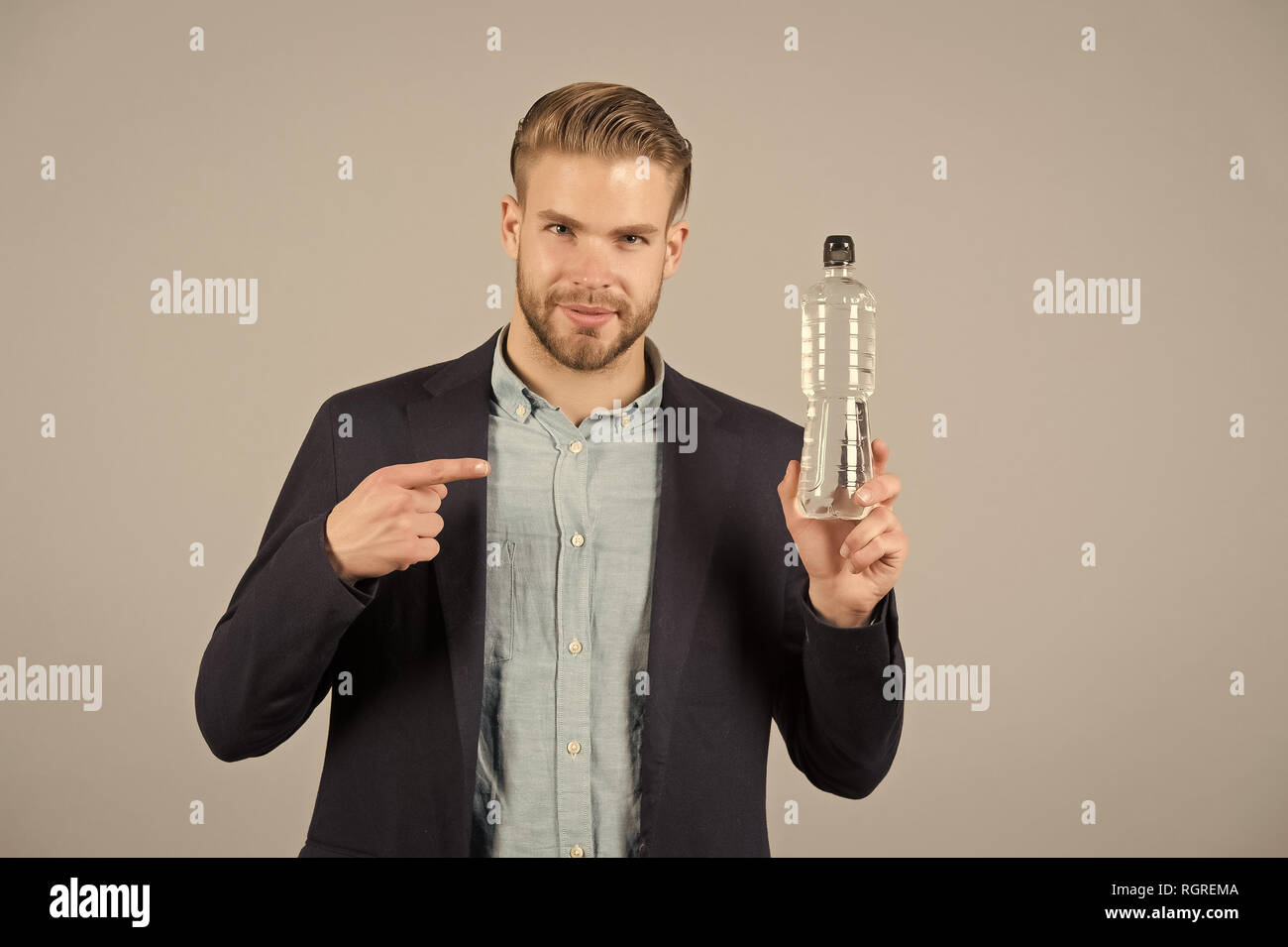 Man point finger at plastic bottle. Thirsty man with water bottle ...