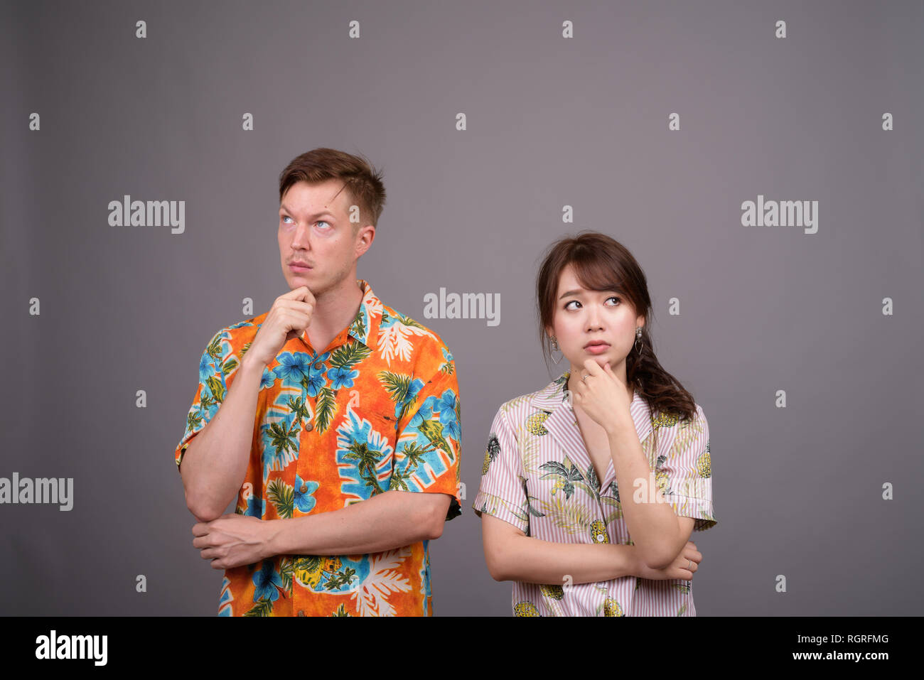 Portrait of multi ethnic tourist couple thinking and planning Stock ...