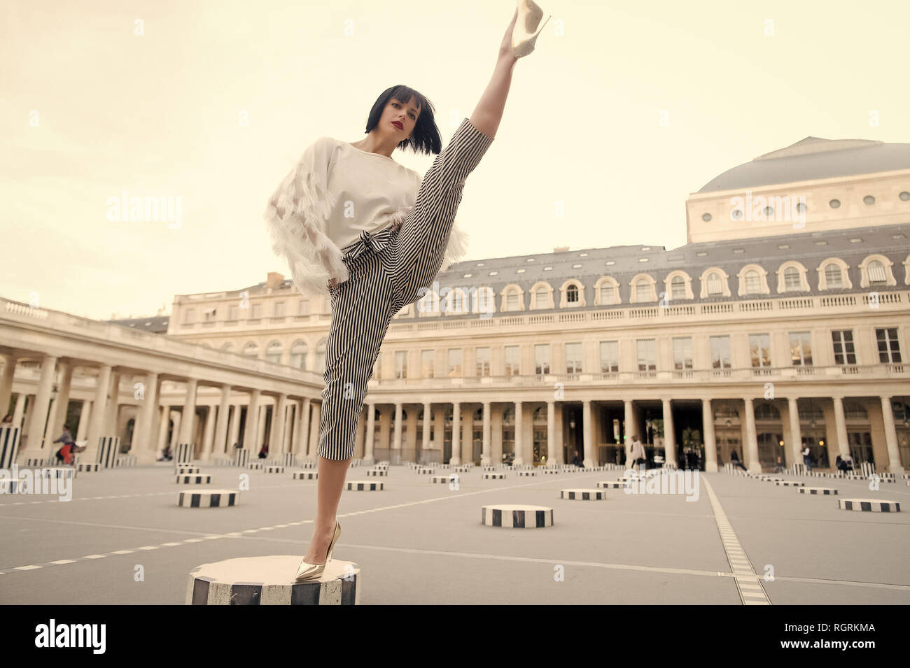 Young stylish woman in pants with split on street in Paris, France ...