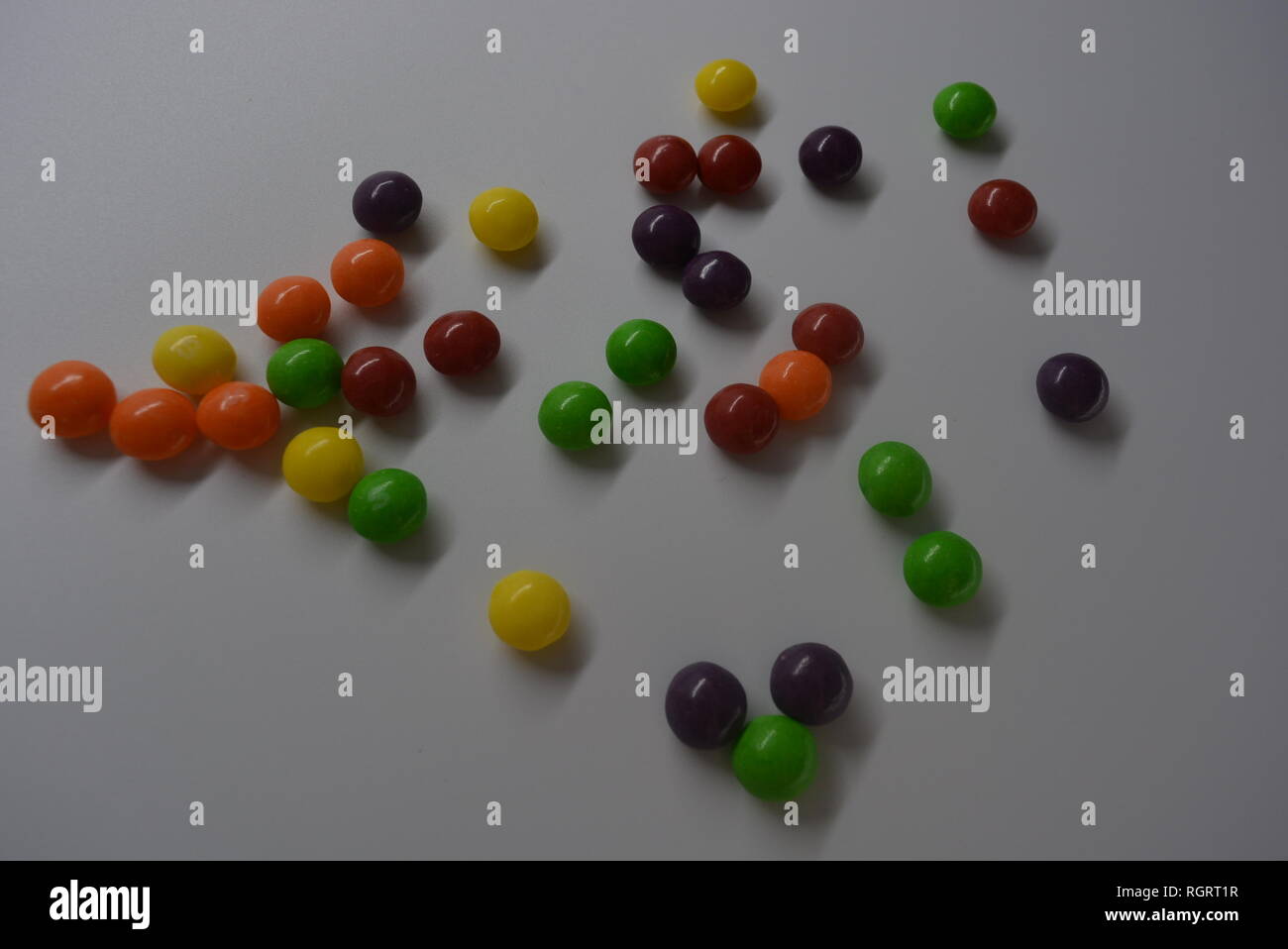 Bright sweet and tasty candies, yellow, pink, orange, green and purple ...