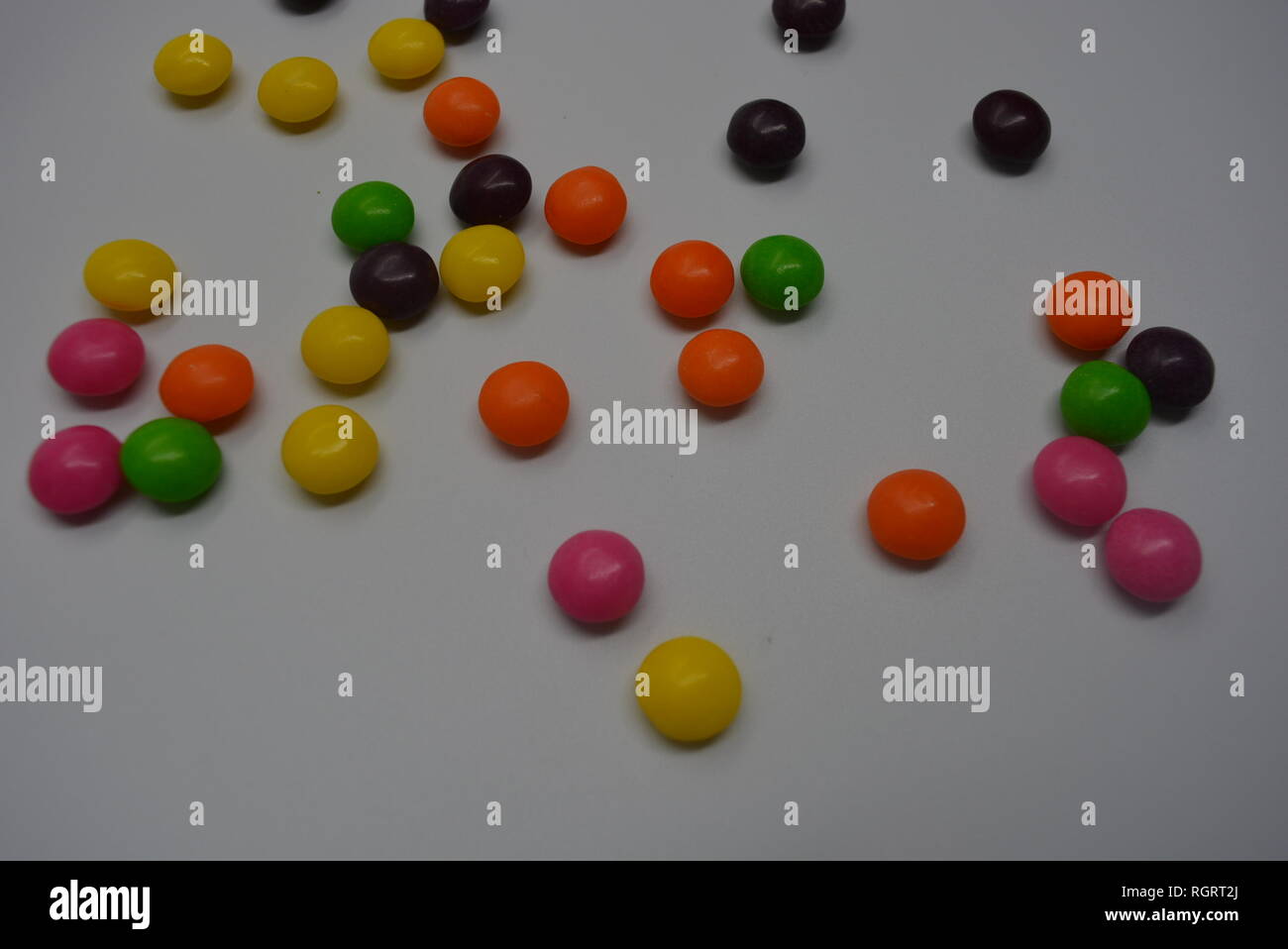 Bright sweet and tasty candies, yellow, pink, orange, green and purple ...