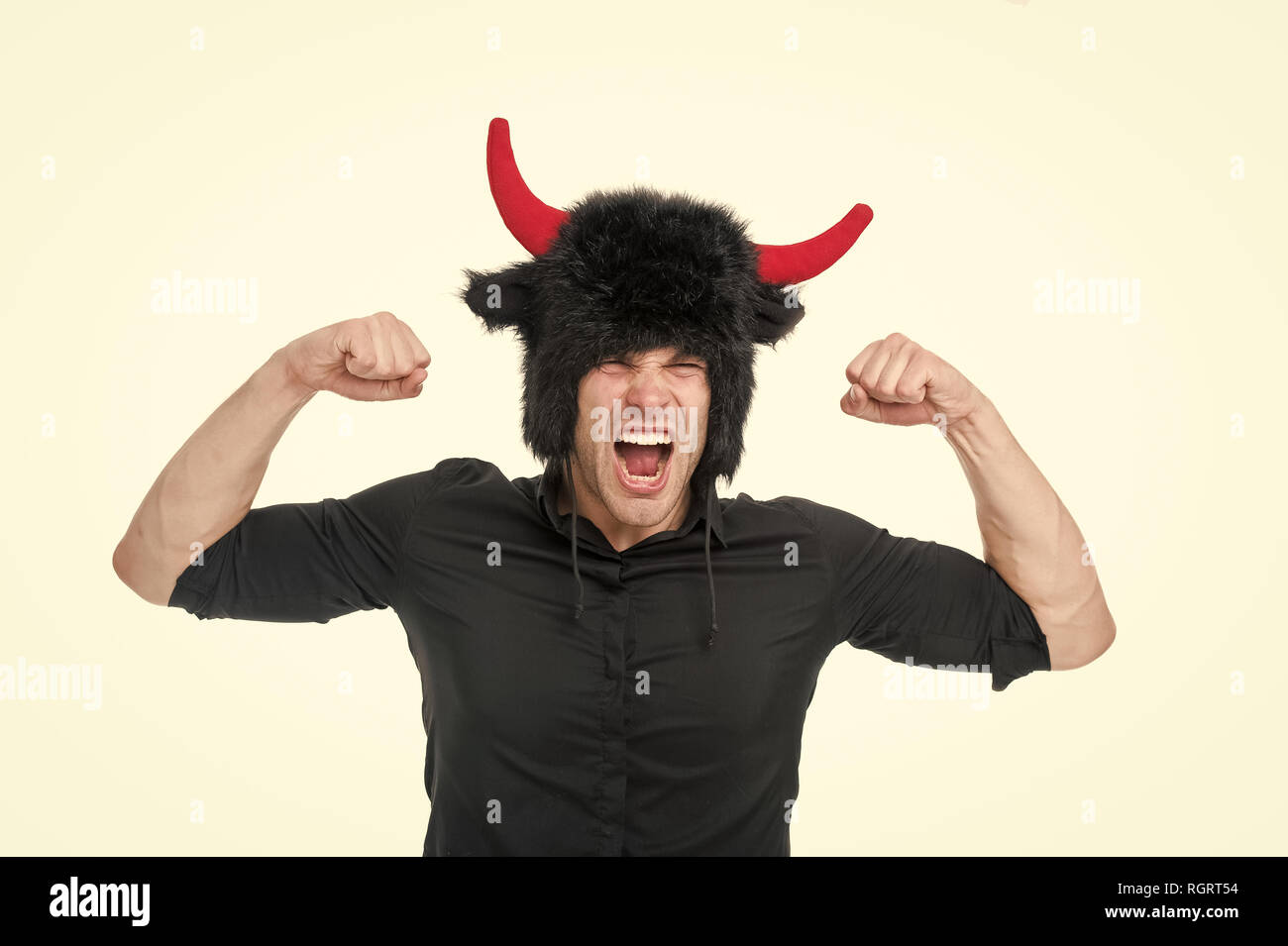Feeling so angry. Man shouting face wears hat of devil with horns. Guy ...