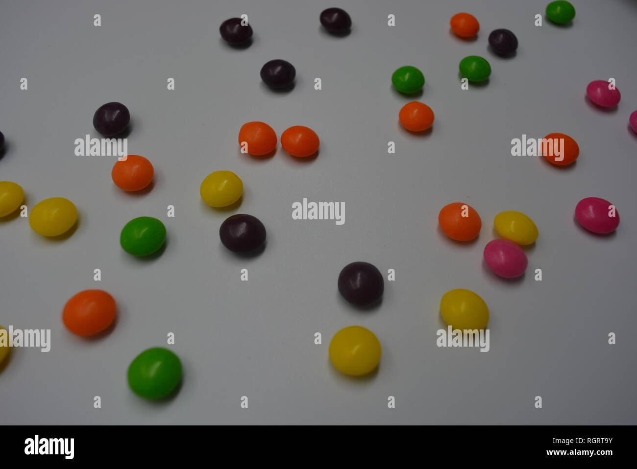 Bright sweet and tasty candies, yellow, pink, orange, green and purple ...