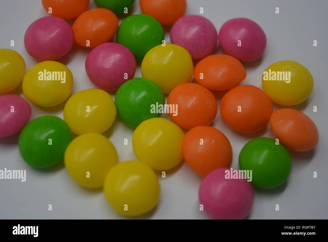 Bright sweet and tasty candies, yellow, pink, orange, green and purple ...