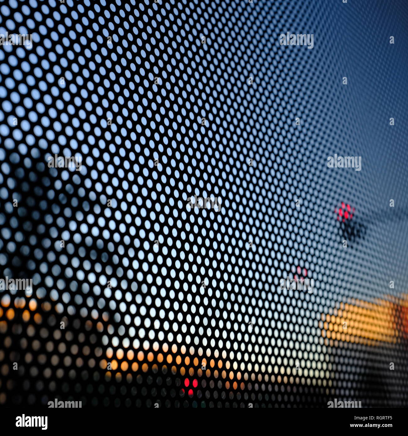 Abstract shot through mesh screen on bus with traffic lights and palm ...