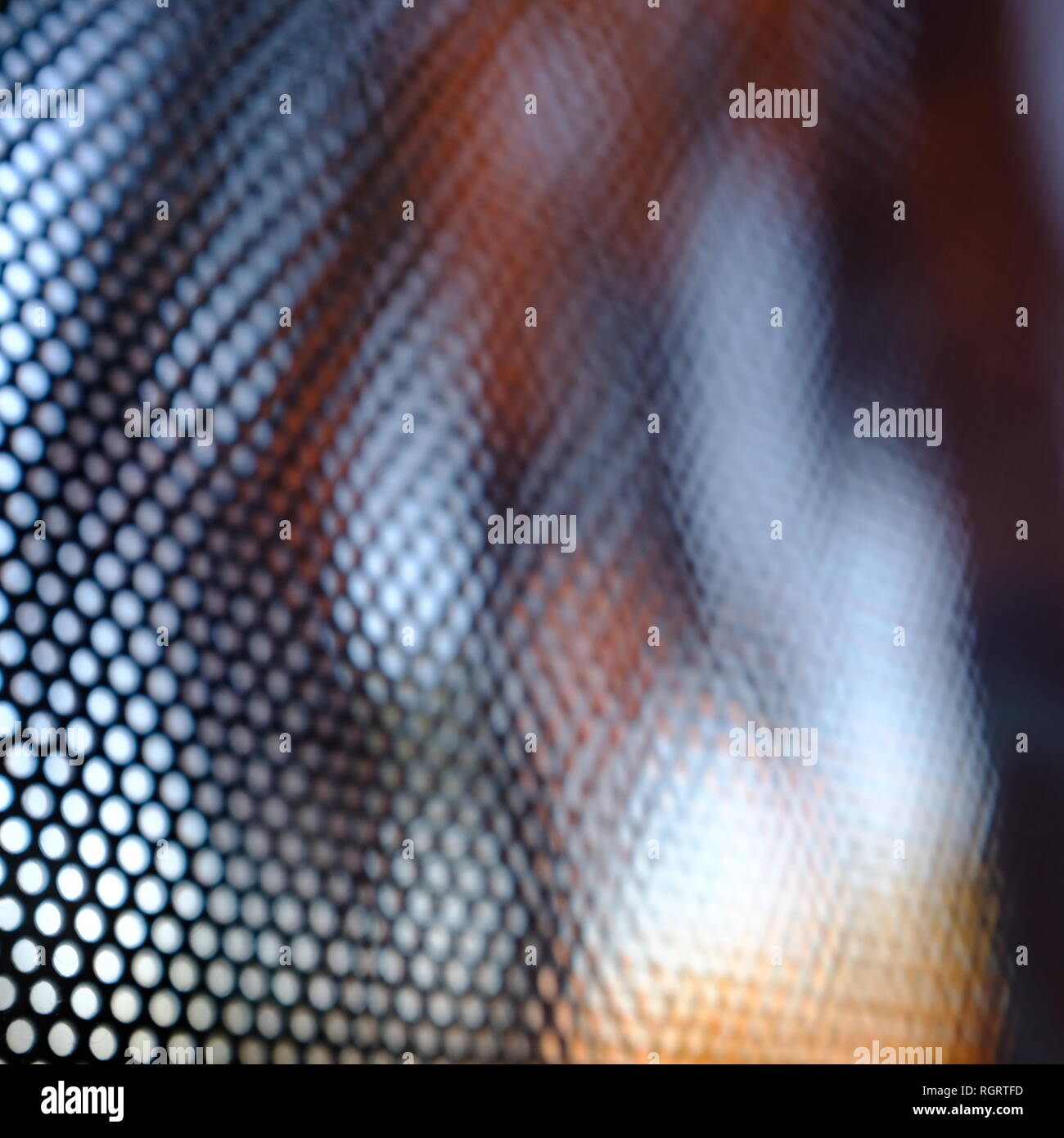 Abstract shot through mesh screen on bus with traffic lights and palm ...