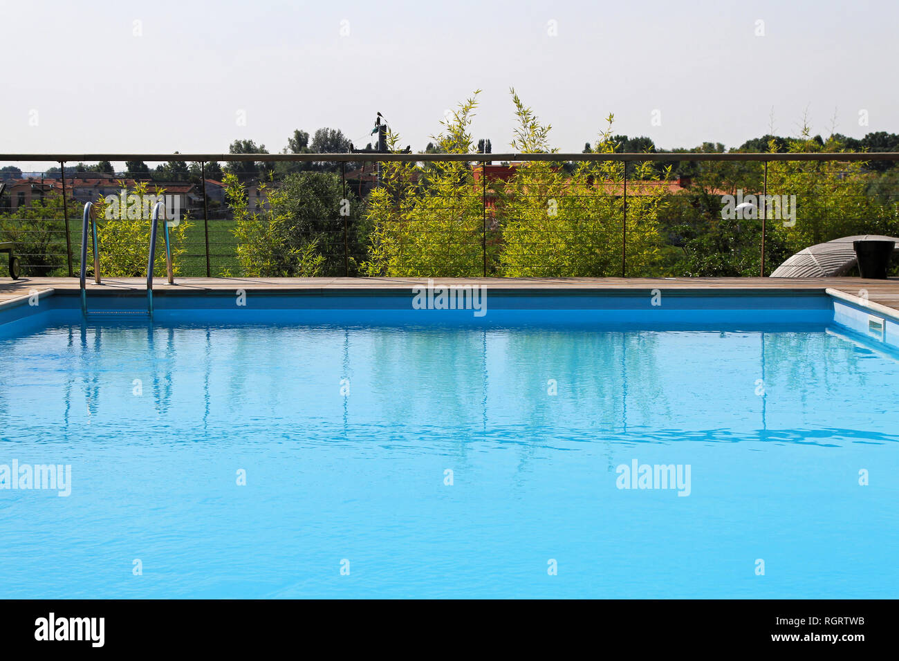 Rooftop outdoor swimming pool with blue water Stock Photo - Alamy