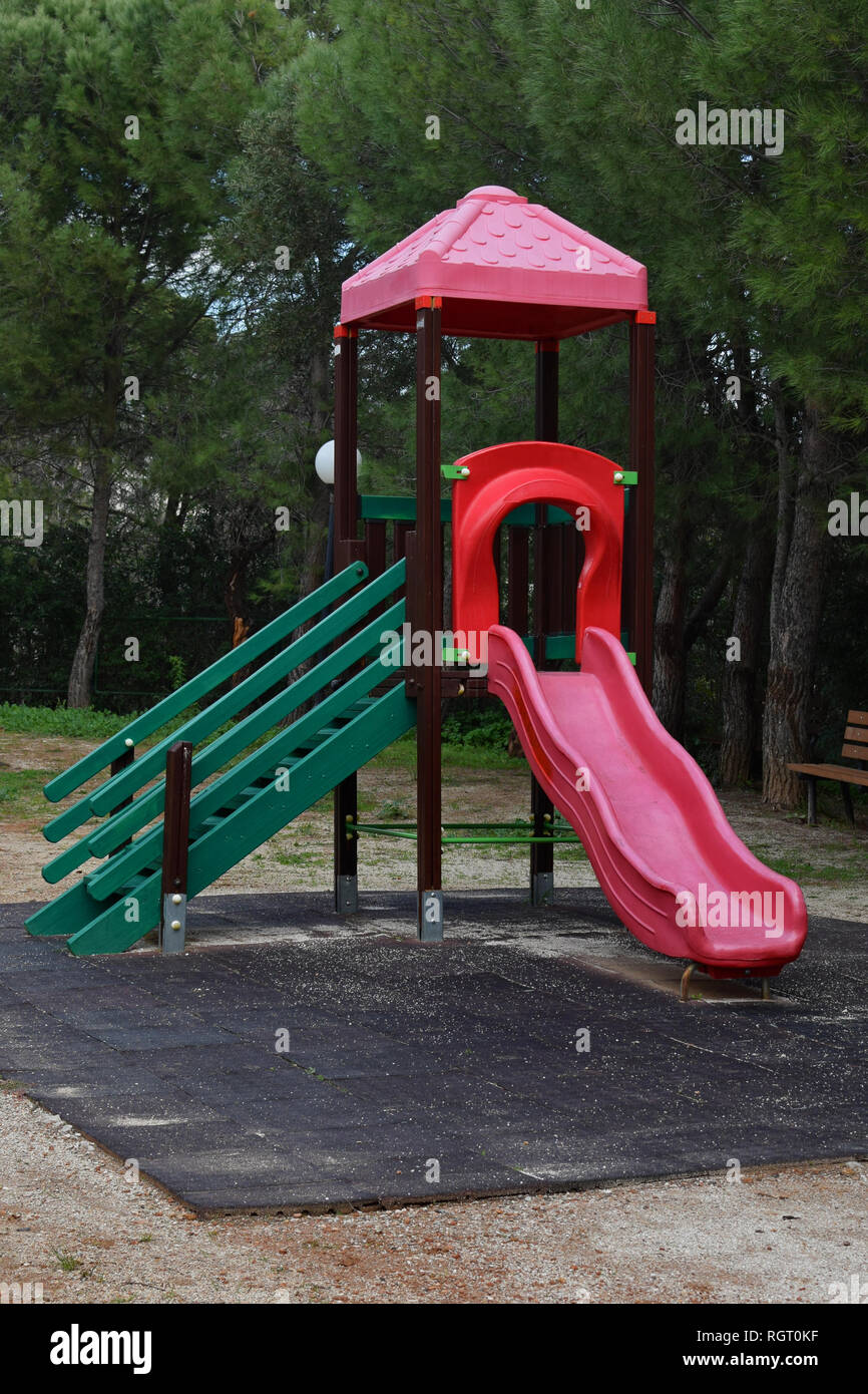 Colorful slide at children's playground and protective safety mat Stock ...