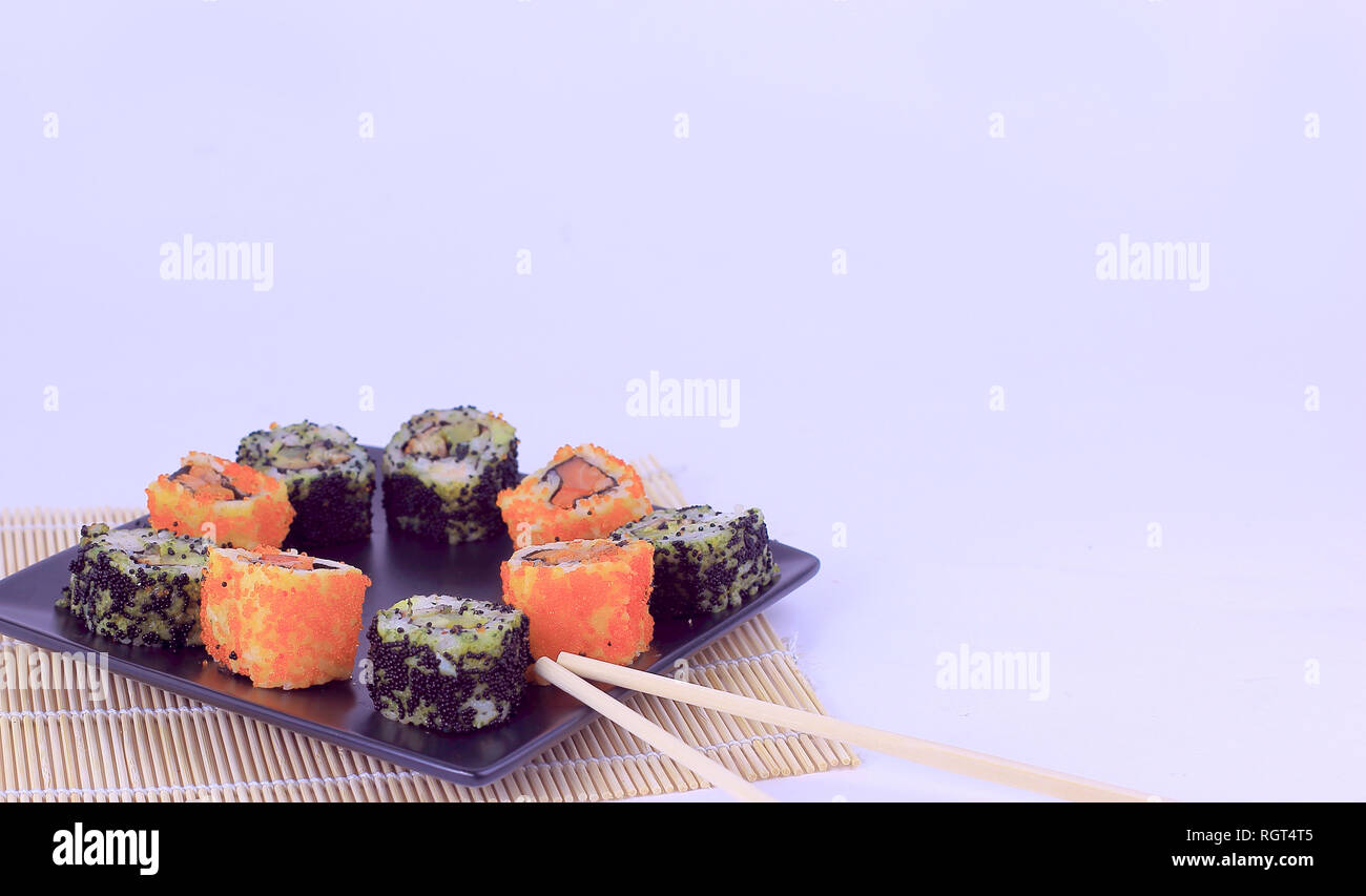 Sushi Set - different types of Maki sushi and chopsticks on a b Stock ...
