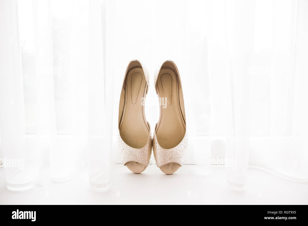 Gorgeous wedding shoes in heels on a white background Stock Photo - Alamy