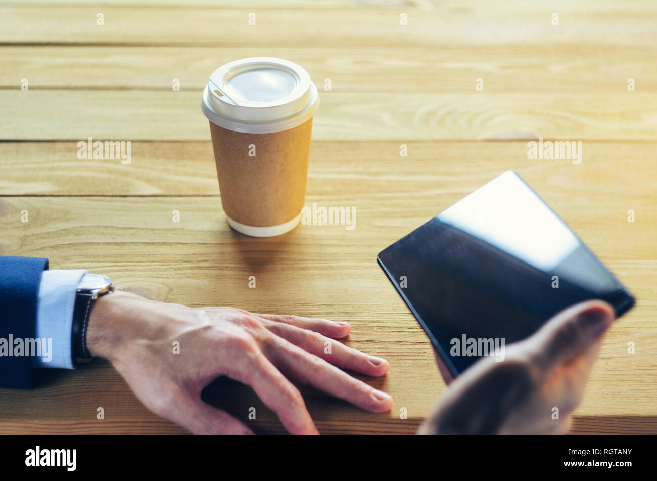Businessman at a table in a cafe. Cup of coffee Tablet Blazer Hands ...
