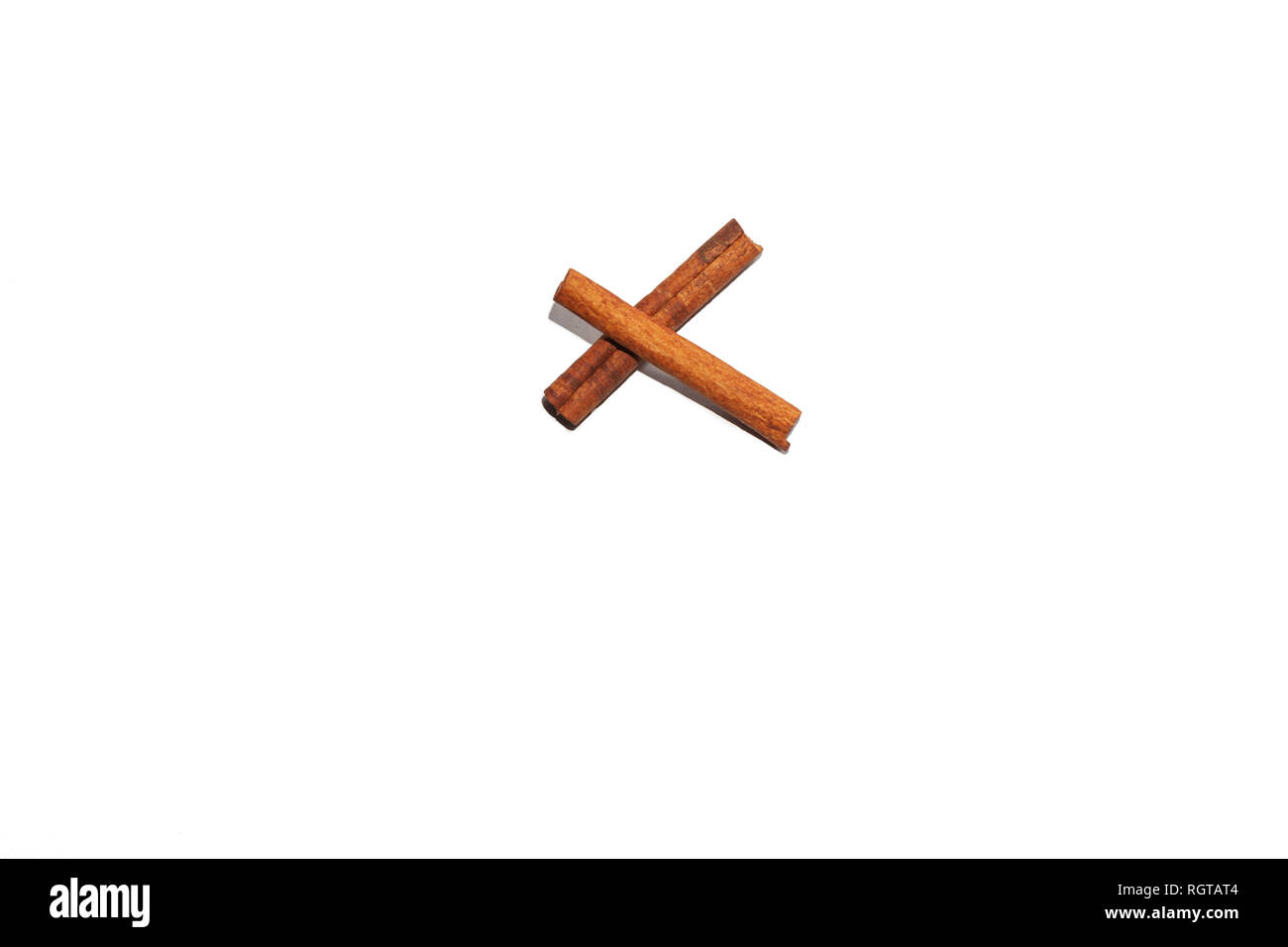 Cinnamon sticks lie cross on a white background, a popular aromatic ...