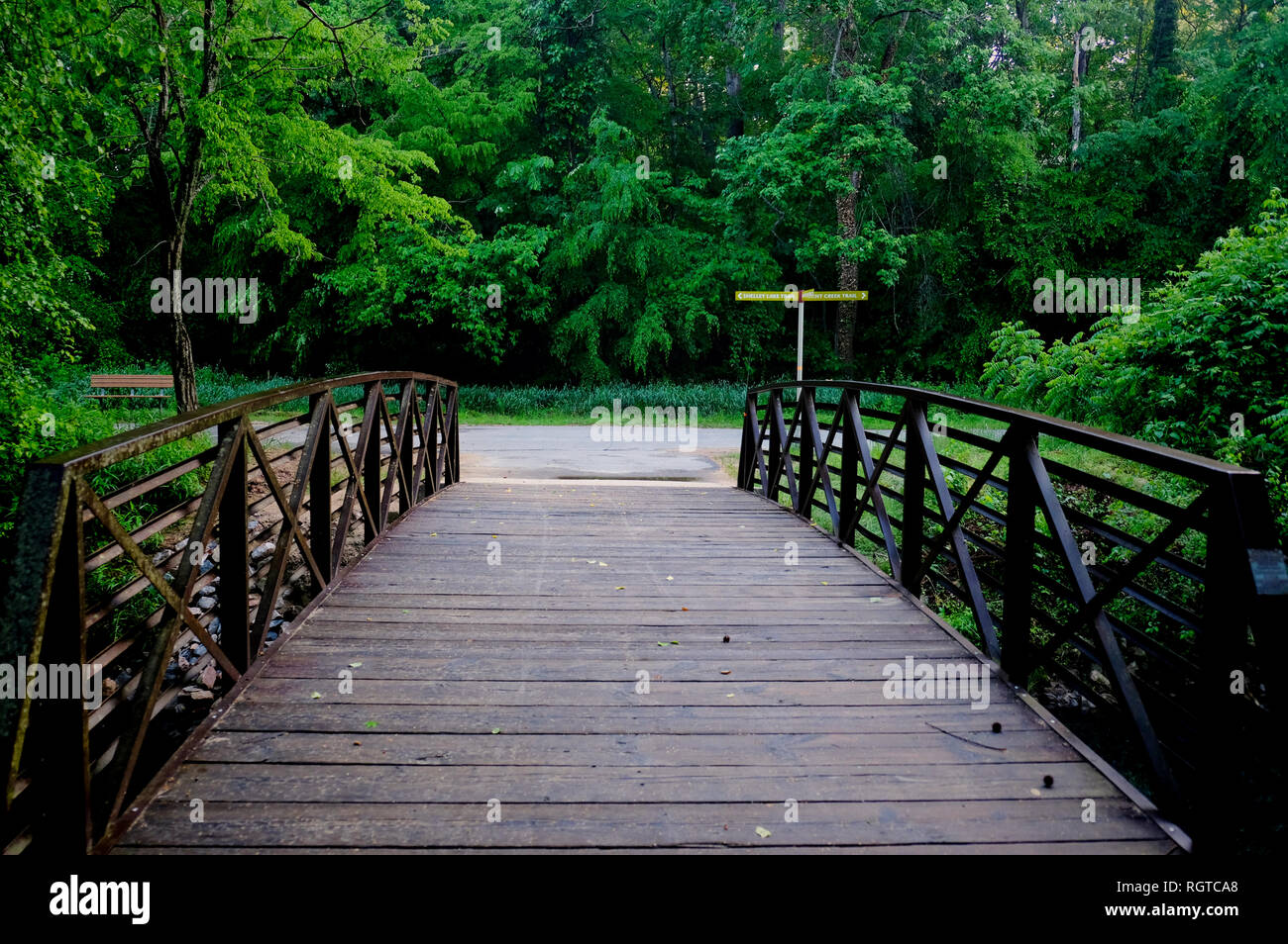 A small arched footbridge spans a creek along the greenway at Shelley ...