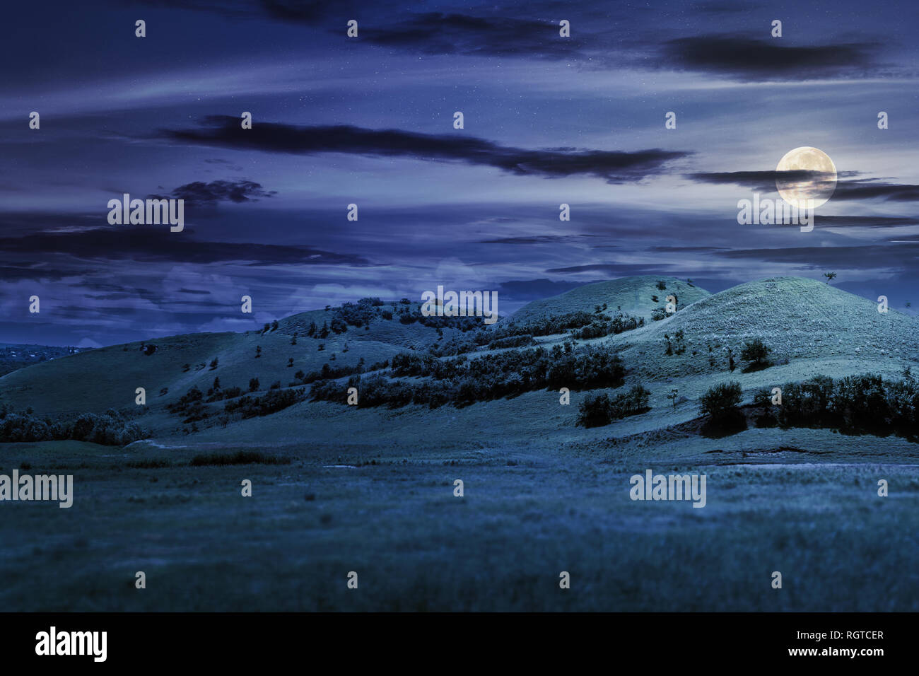 three hills in summer landscape at night in full moon light. beautiful ...
