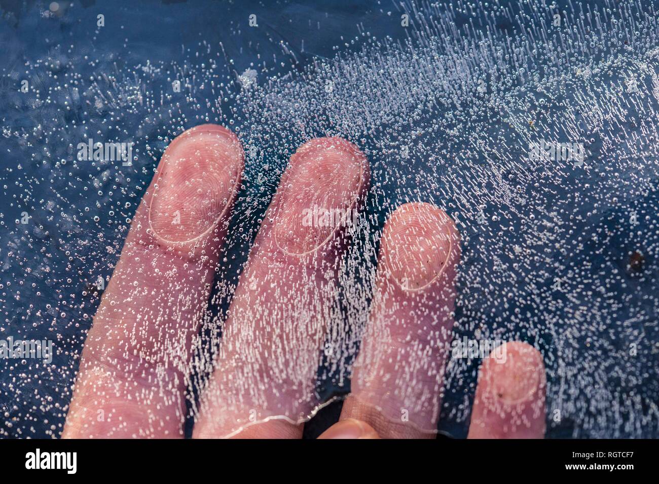 Close-up of fingers holding ice Stock Photo - Alamy