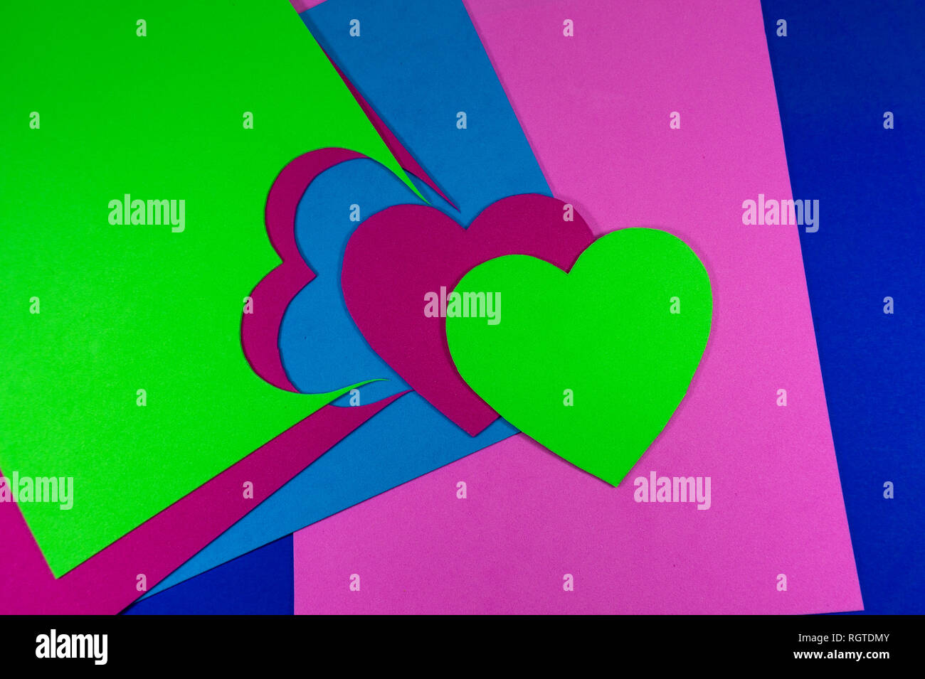 Hearts cut out of bright color foam sheets viewed in full frame ...