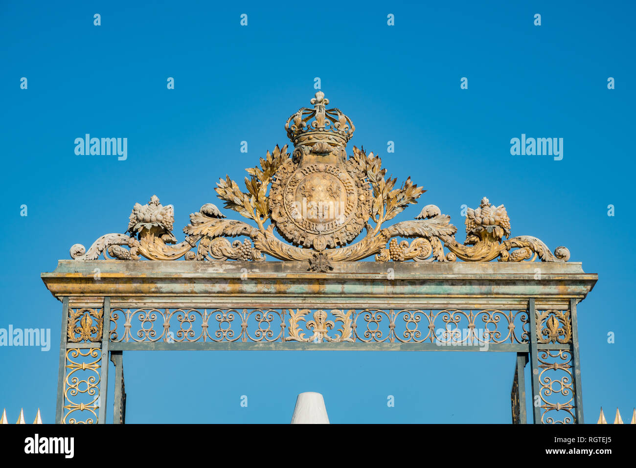 The golden entrance gate of the famous Palace of Versailles at France ...