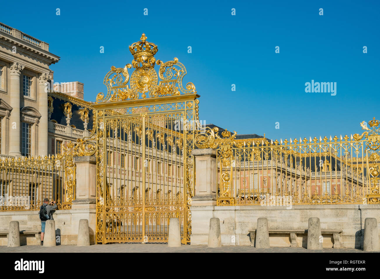 The golden entrance gate of the famous Palace of Versailles at France ...