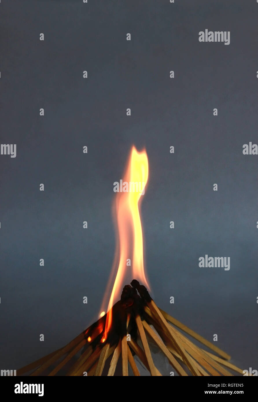 bonfire, wood sticks catching fire, burning flame in front of dark ...