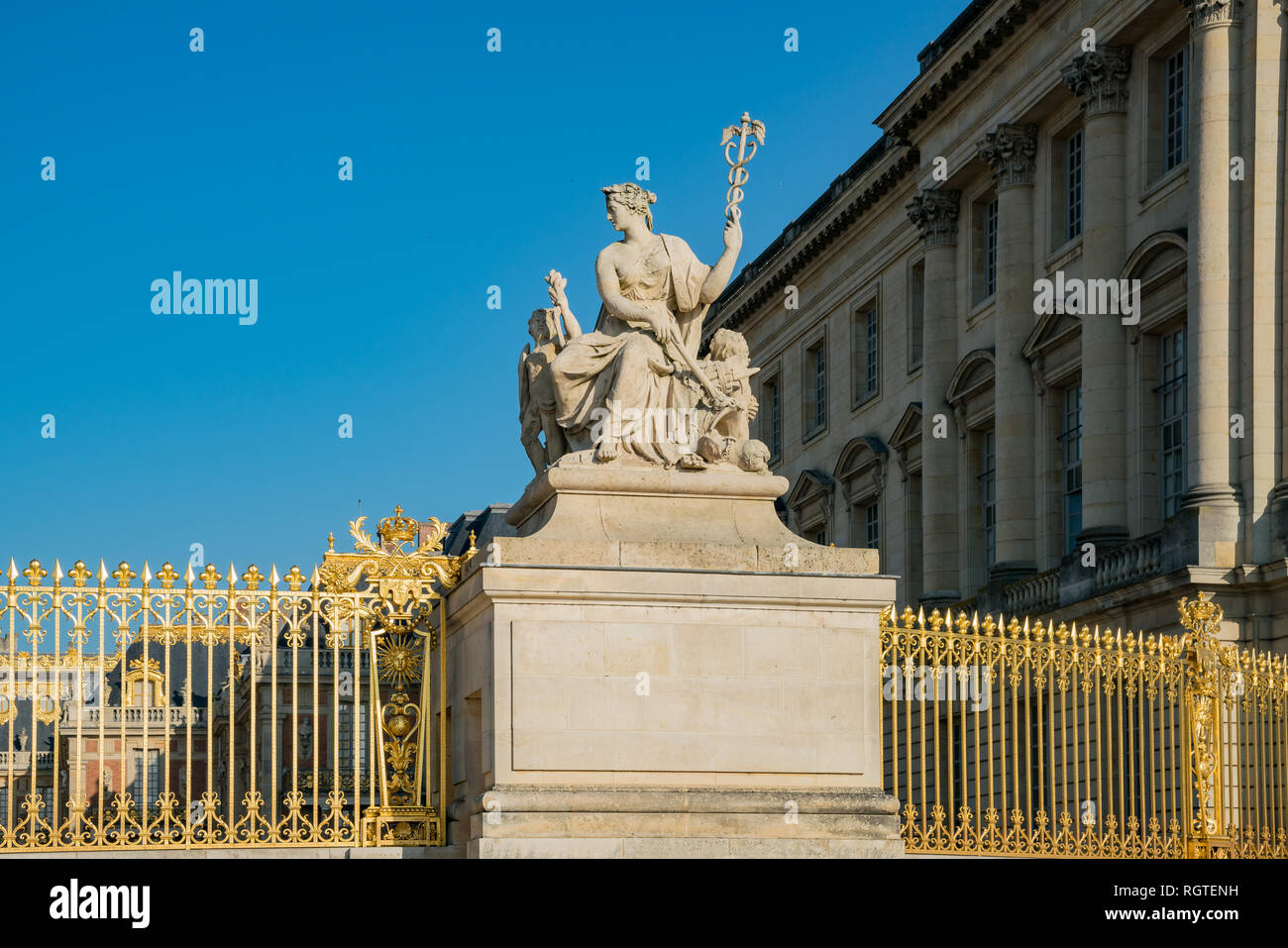 The golden entrance gate of the famous Palace of Versailles at France ...