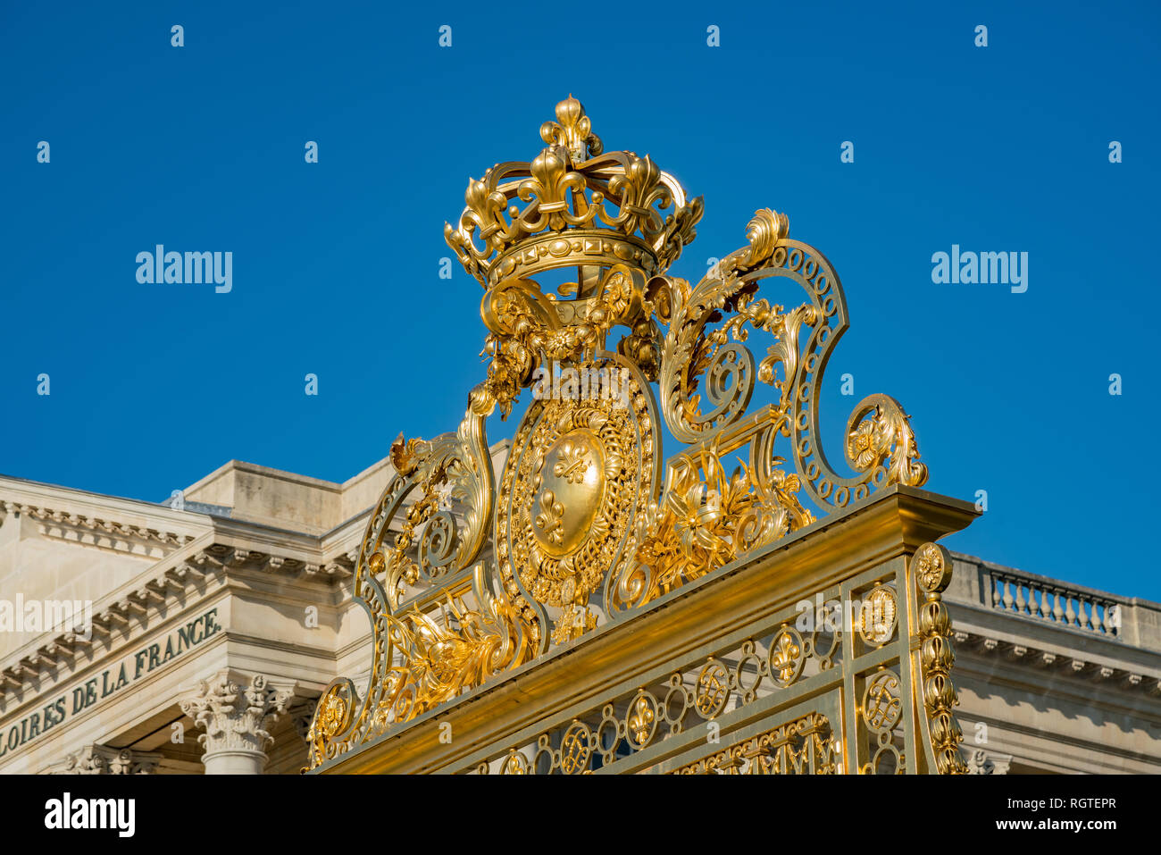 The golden entrance gate of the famous Palace of Versailles at France ...