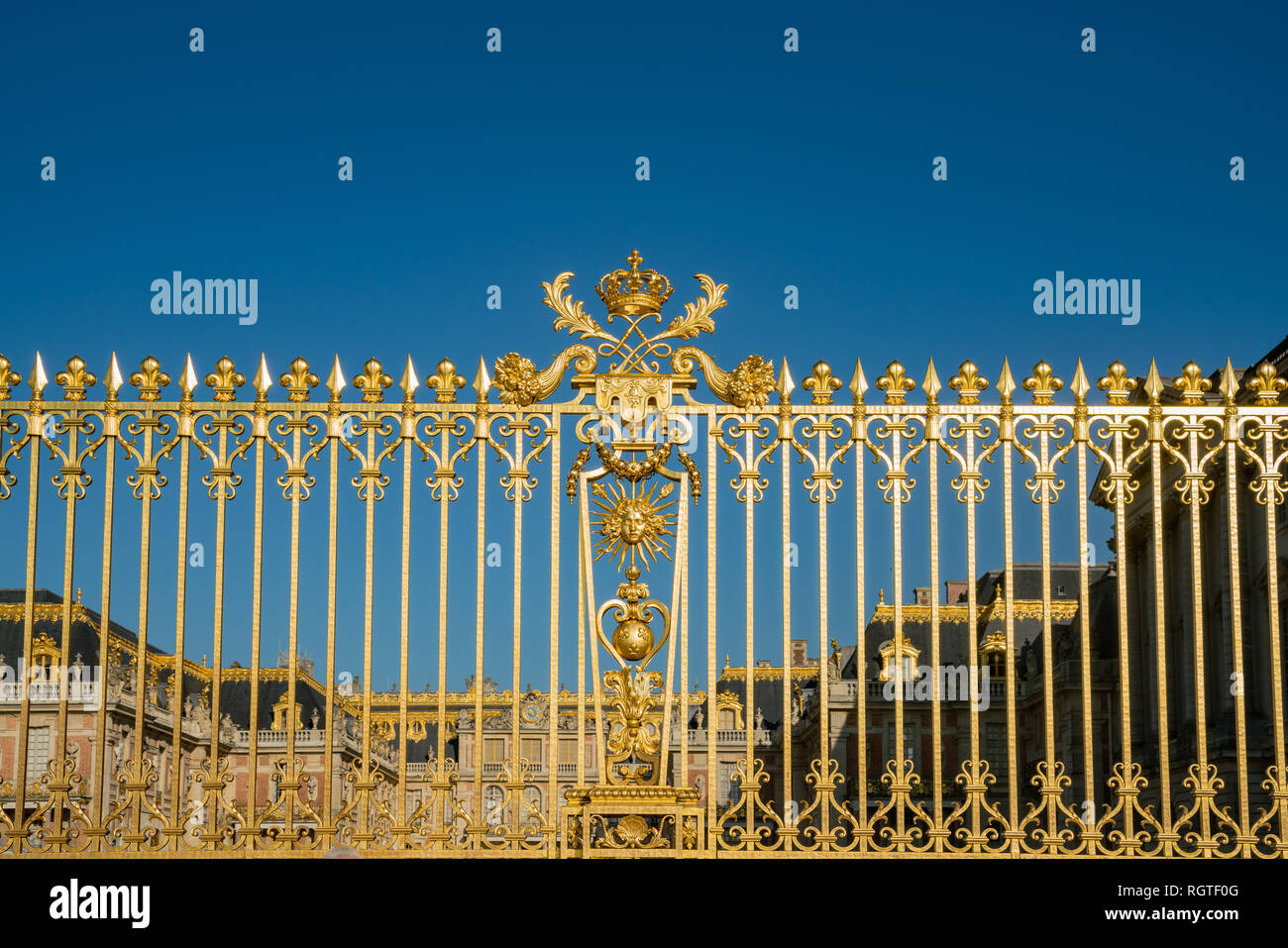 The golden entrance gate of the famous Palace of Versailles at France ...