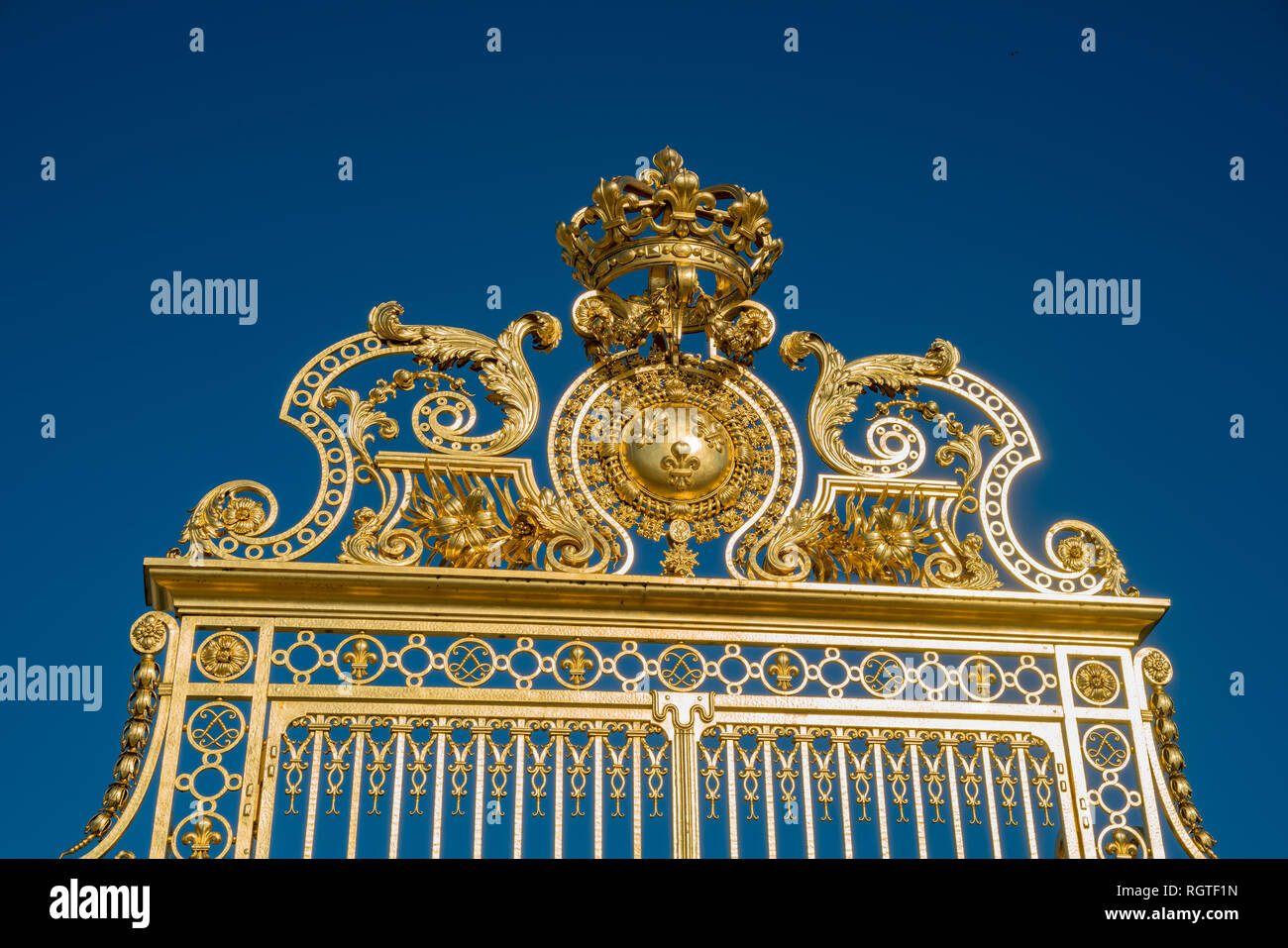 The golden entrance gate of the famous Palace of Versailles at France ...