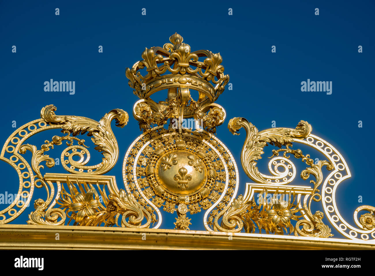 The golden entrance gate of the famous Palace of Versailles at France ...