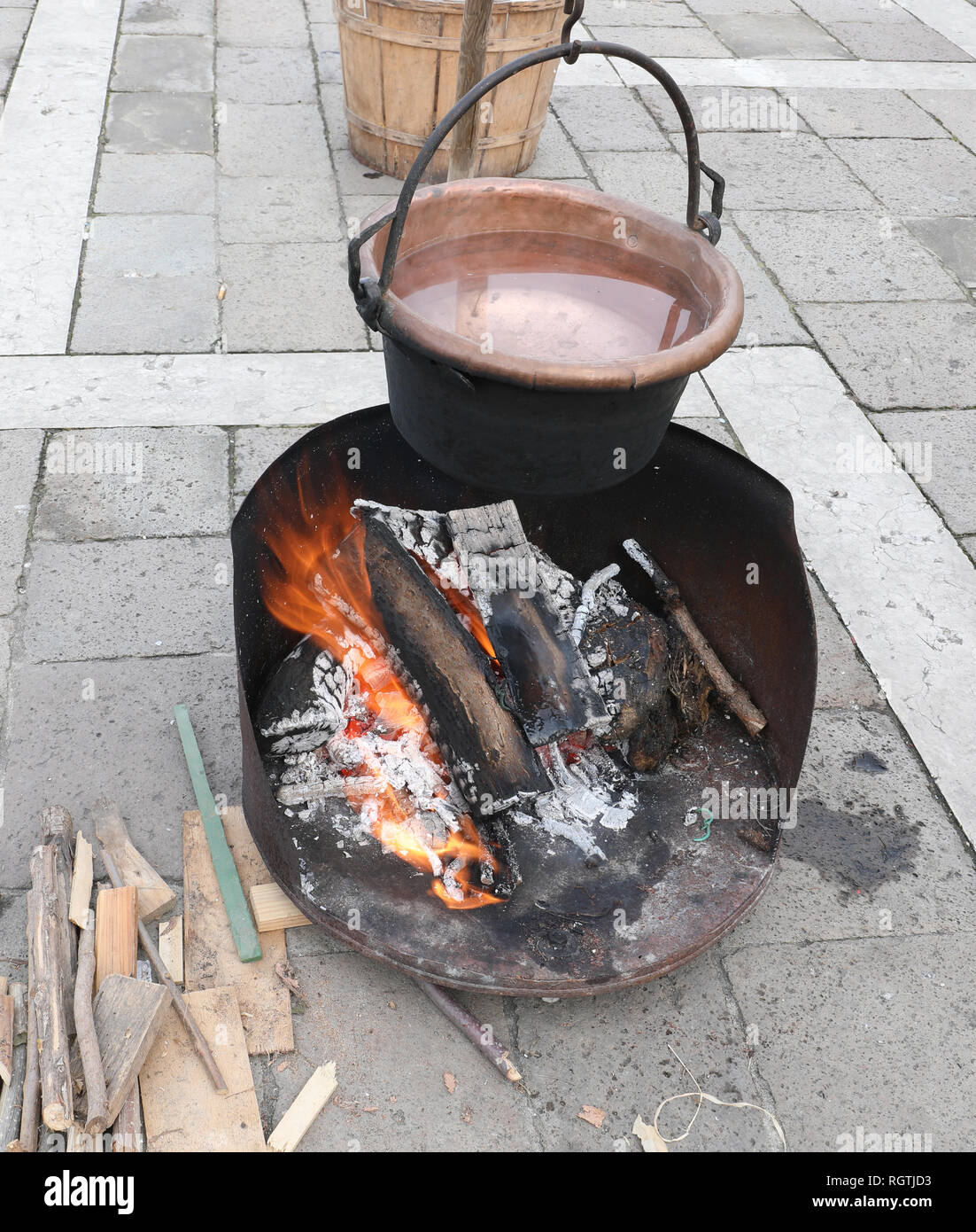 old copper cauldron over the fire made of burning woods and boiling ...