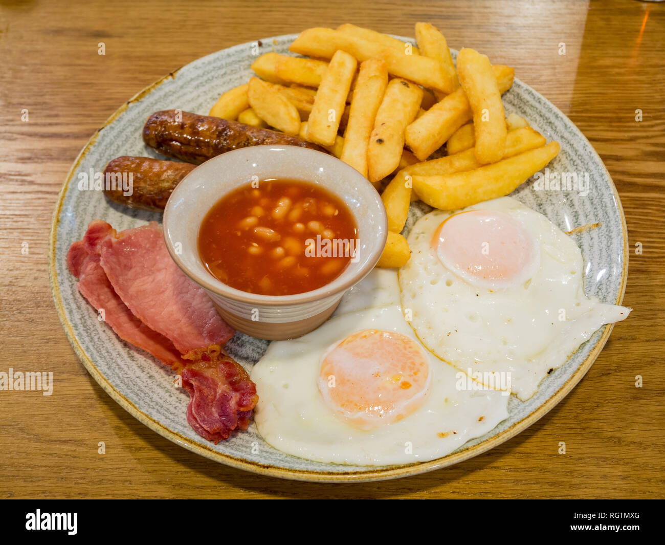 Close up shot of a set of breakfast, including french fries, ham ...