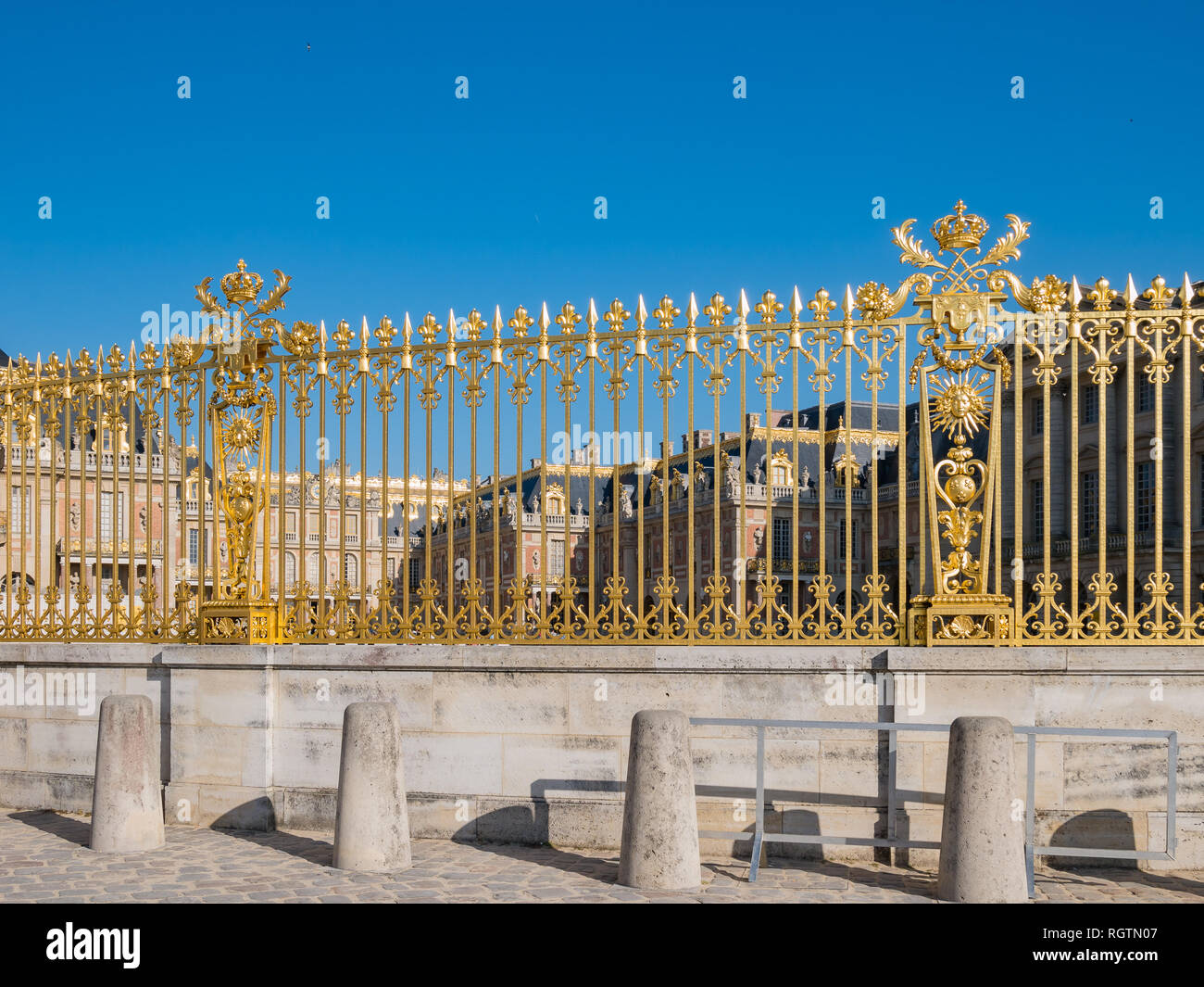 The golden entrance gate of the famous Palace of Versailles at France ...