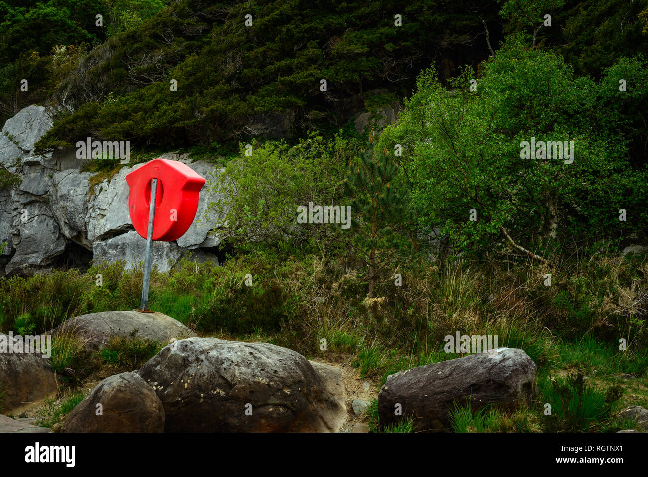Orange lifebuoy stand mounted on a boulder at Muckross Lake in ...