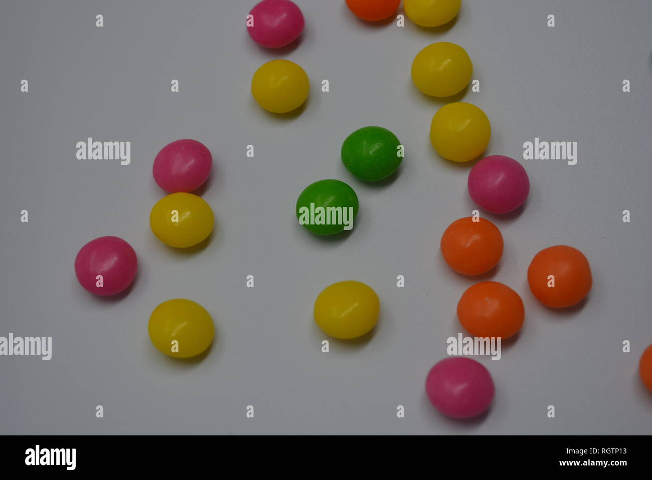 Bright sweet and tasty candies, yellow, pink, orange, green and purple ...