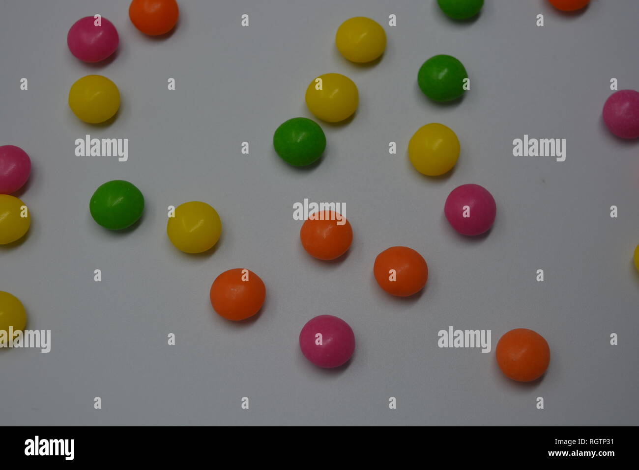Bright sweet and tasty candies, yellow, pink, orange, green and purple ...