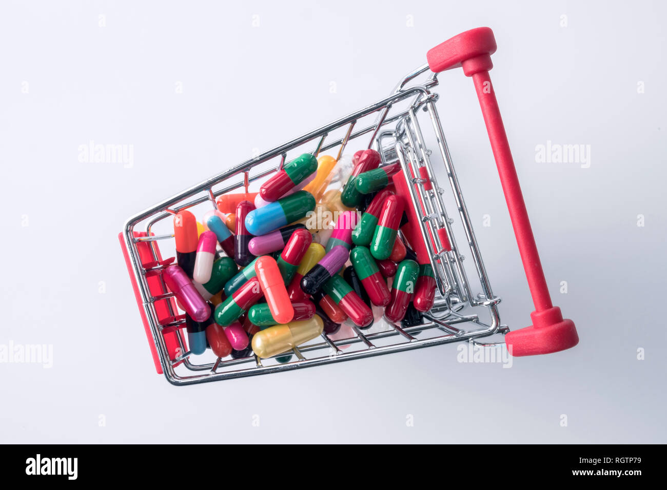 Shopping cart with capsules isolated on white background, composition ...