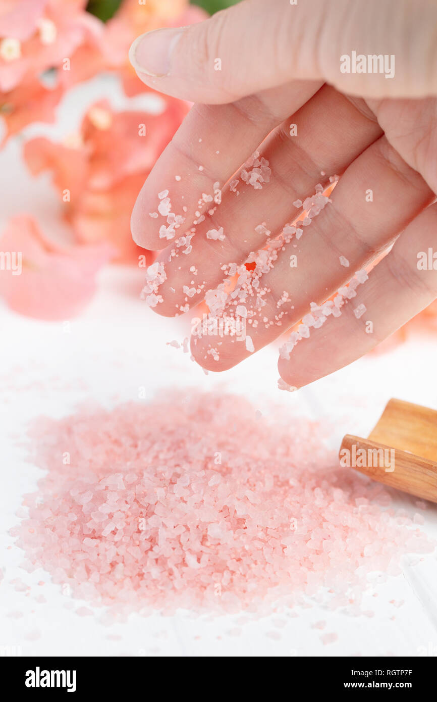 Pink sea salt dripping on a woman's hand Stock Photo - Alamy