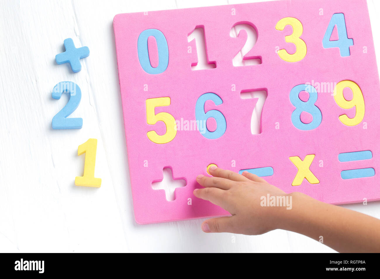 The child is studying the numbers and the account. Arranges the colored ...