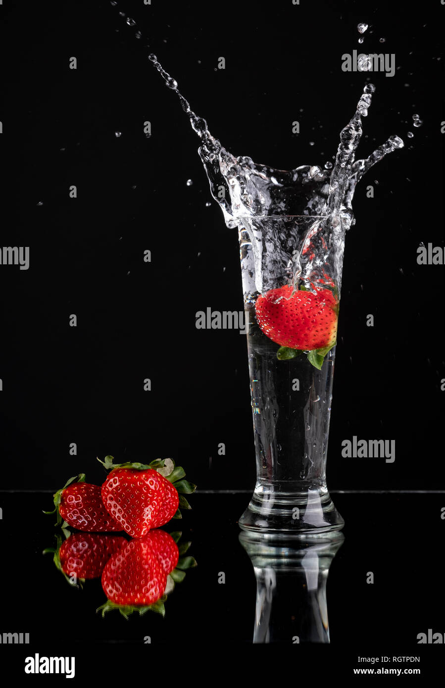 spectacular splash of a strawberry in a glass Stock Photo - Alamy
