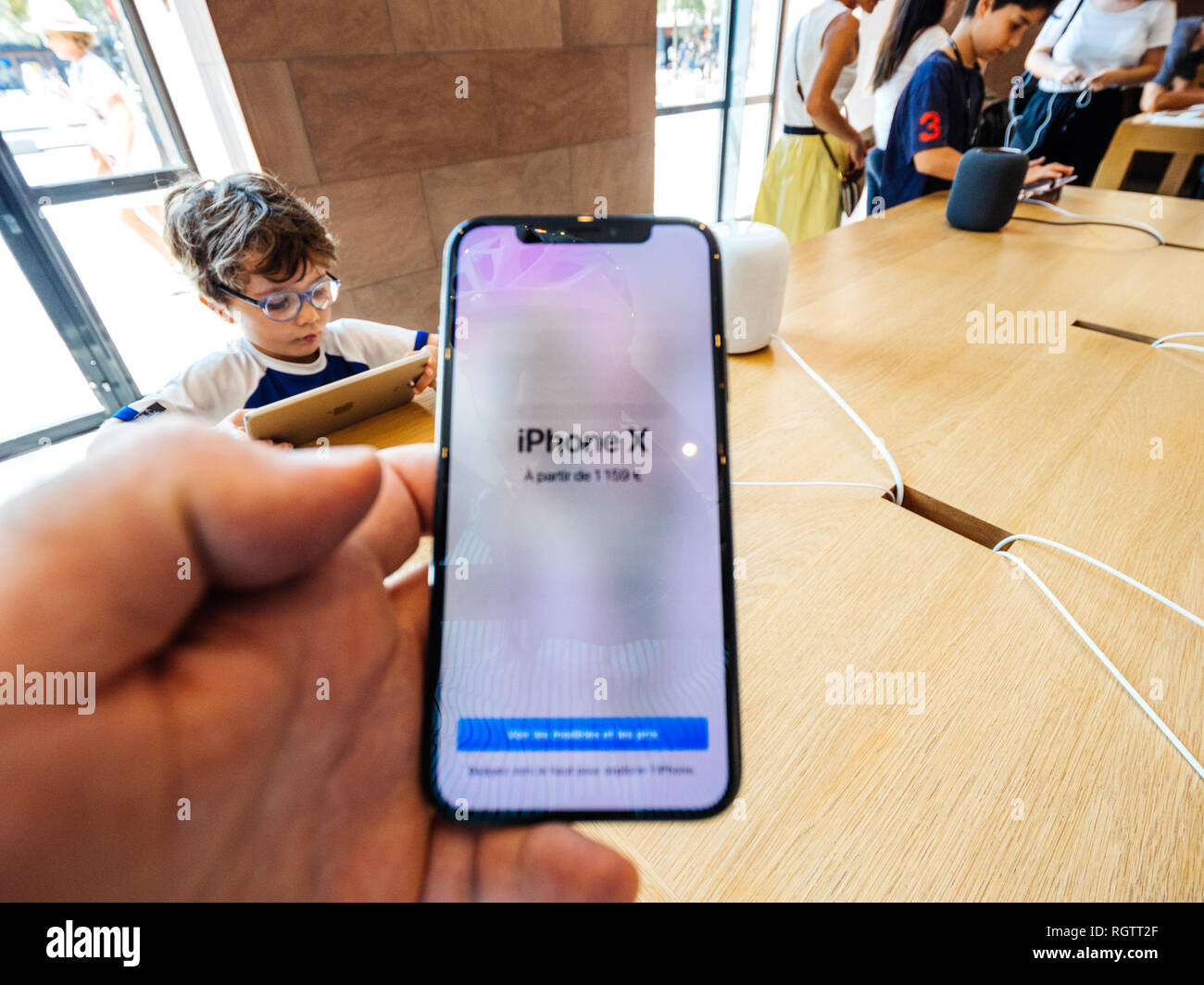 PARIS, FRANCE - JUL 16, 2018: Modern Apple Mac store main hall with man ...