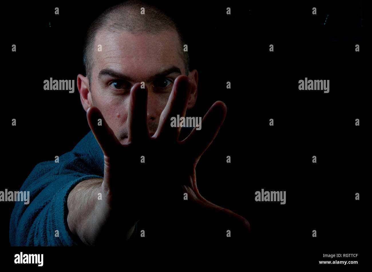 Man reaching out with hand in front of face Stock Photo - Alamy