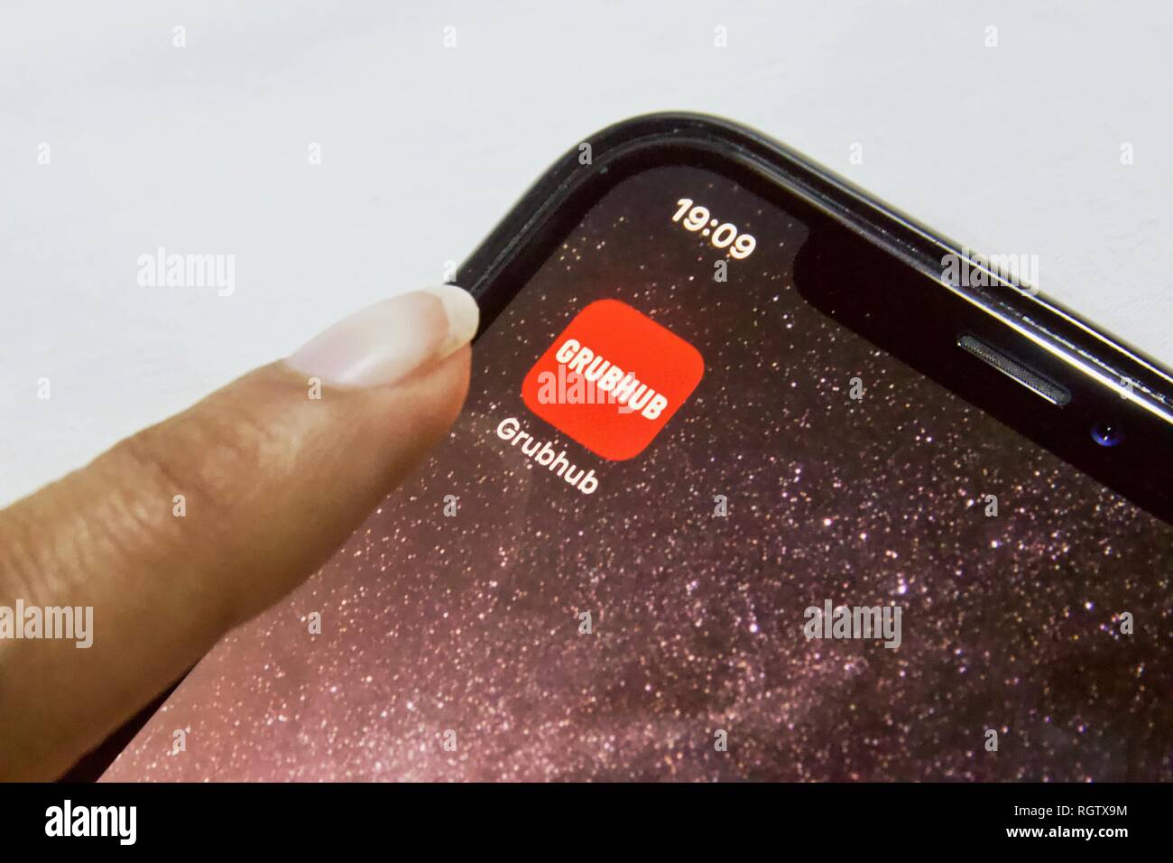 GrubHub app on an iPhone X against a white background. GrubHub is an ...