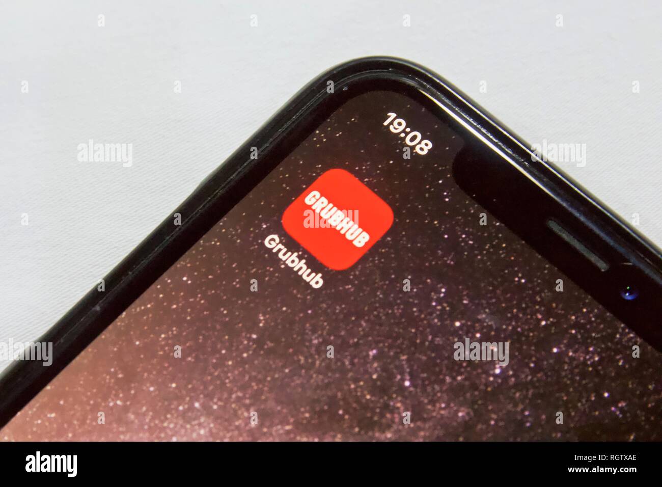 GrubHub app on an iPhone X against a white background. GrubHub is an ...