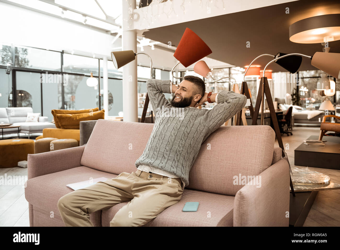Joyful man being tired of shopping process and stretching up Stock ...