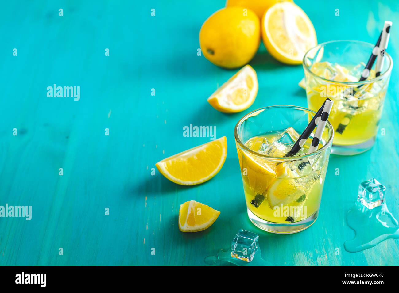 Lemon alcohol drink cocktail with ice, lemon and rosemary herb on a ...