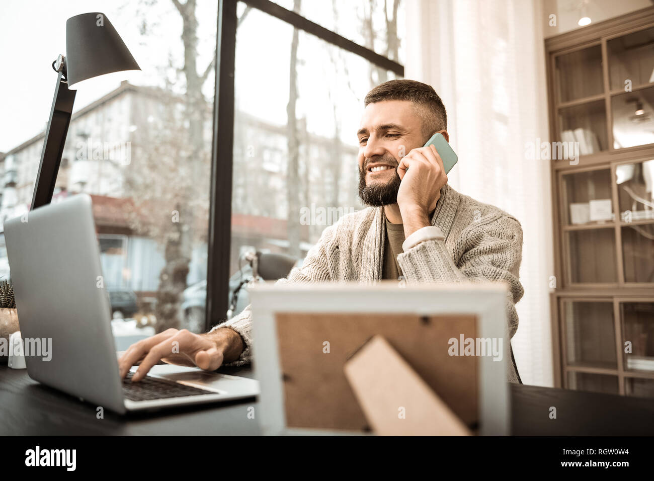 Focused smiling businessman being busy with conversation Stock Photo ...