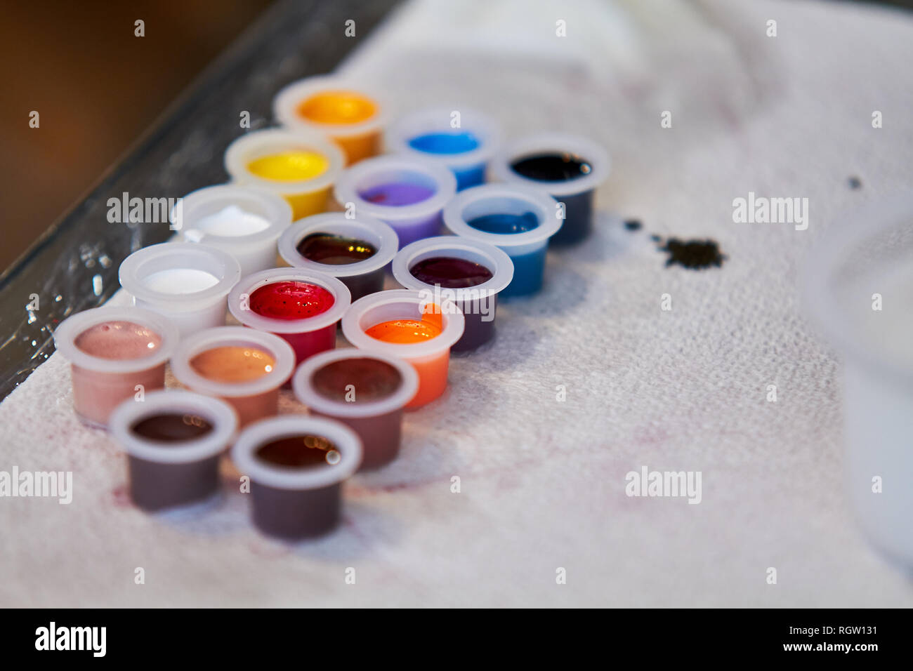 plastics cups with color ink palette for tattoo Stock Photo - Alamy