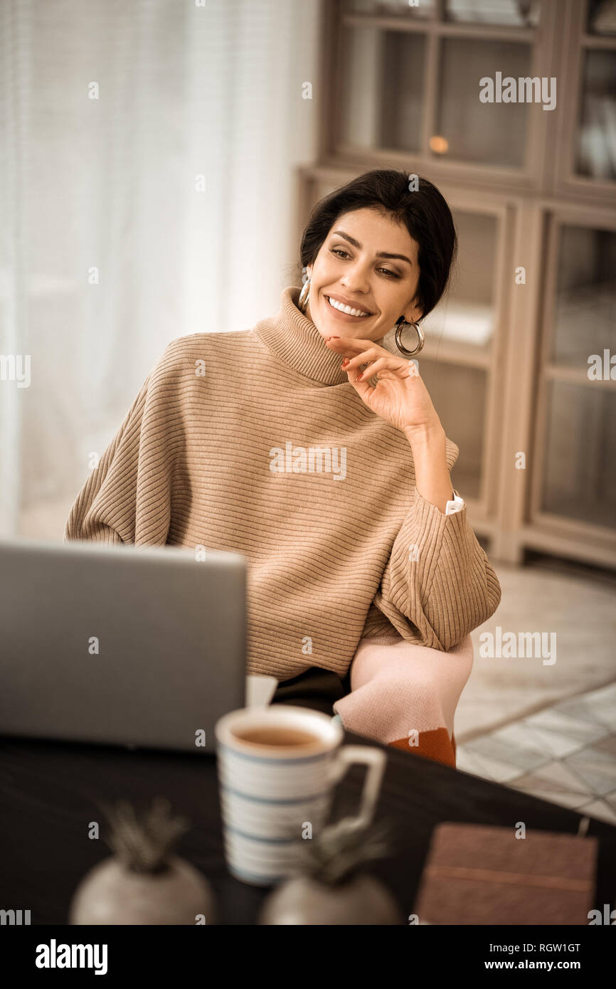 Calm peaceful attractive woman spending time with her laptop Stock ...